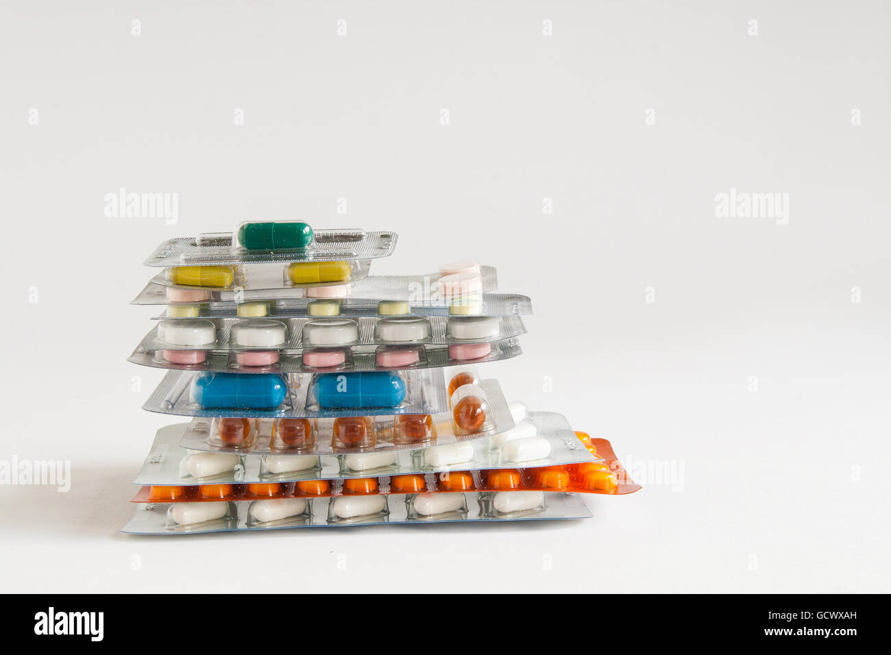 Stack of pills on a white background Stock Photo - Alamy