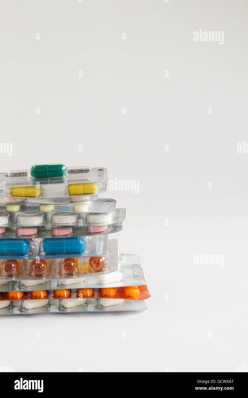 Stack of pills on a white background Stock Photo - Alamy