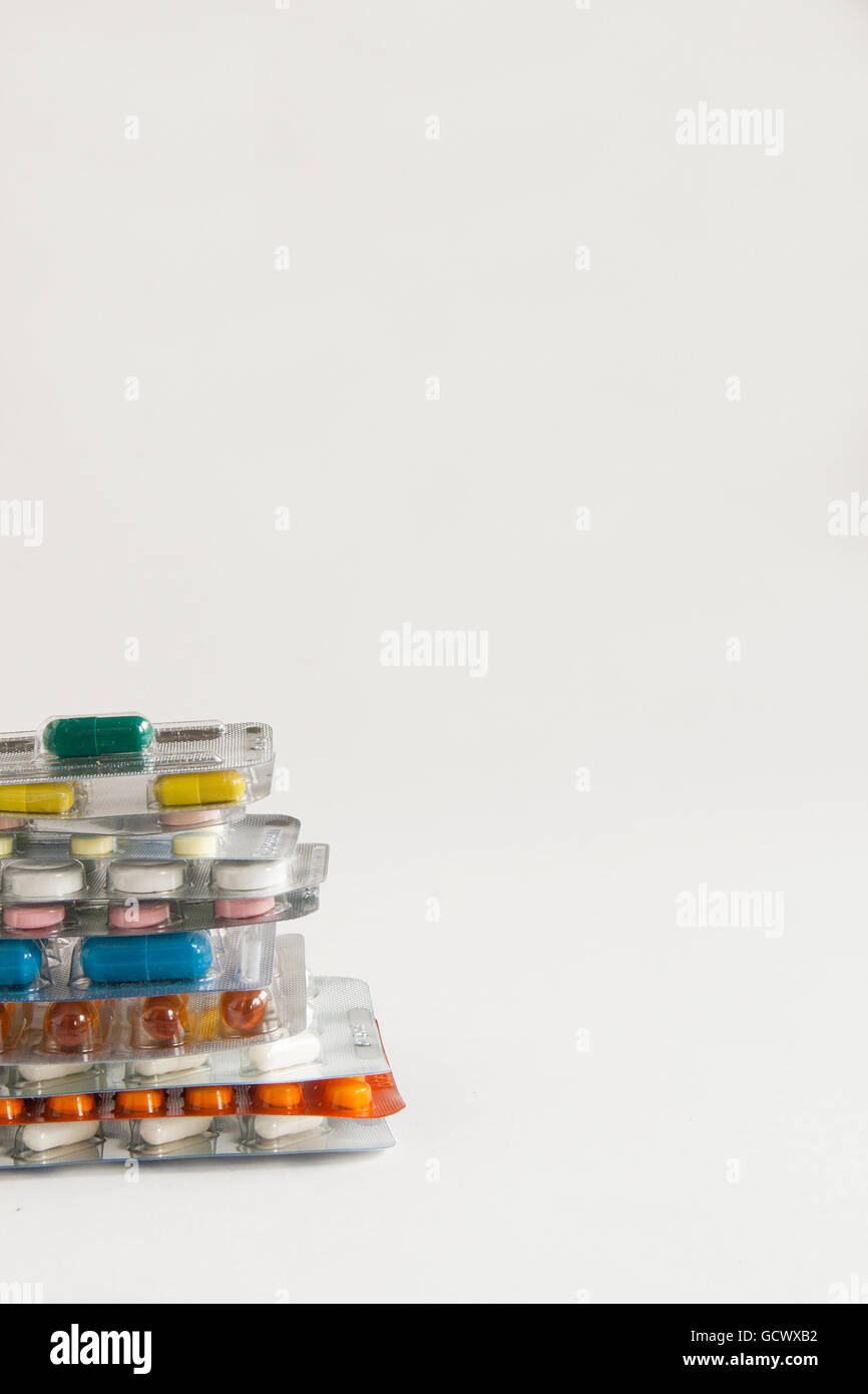 Stack of pills on a white background Stock Photo - Alamy