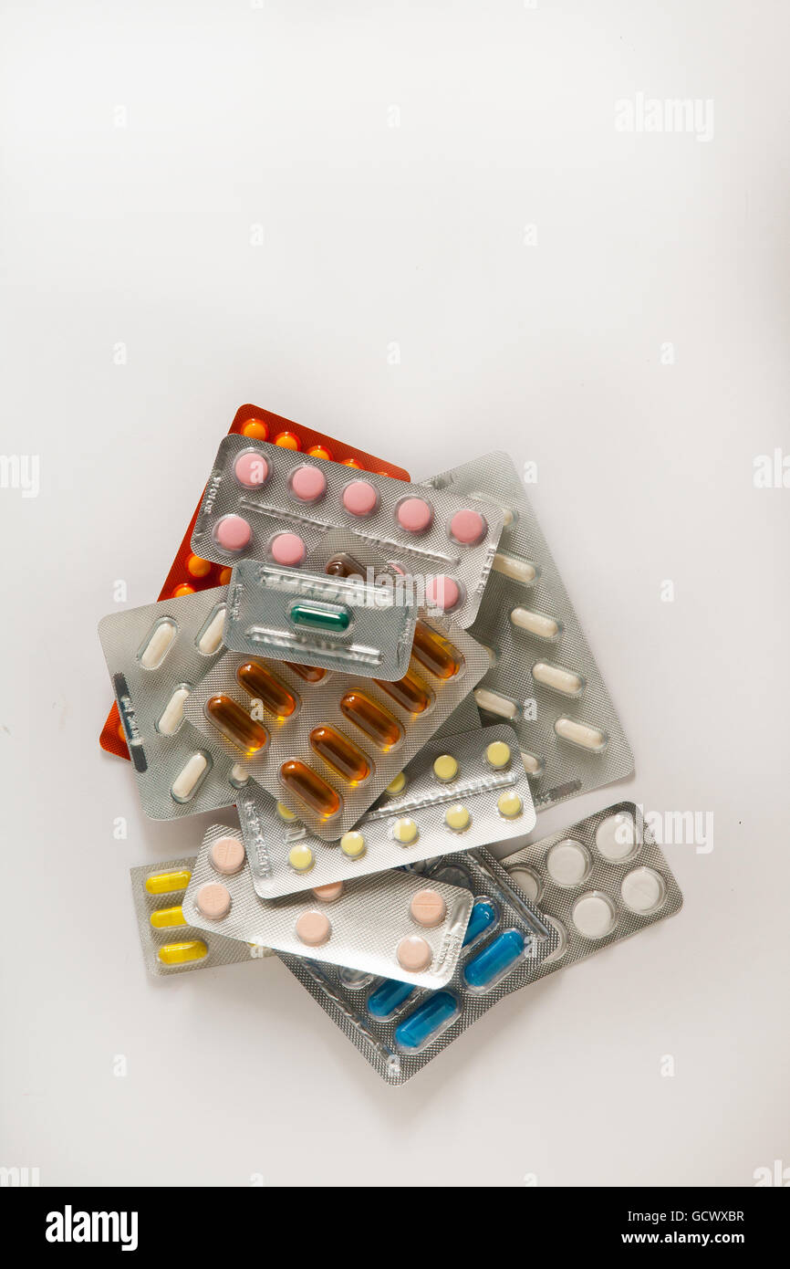Stack of pills on a white background Stock Photo - Alamy