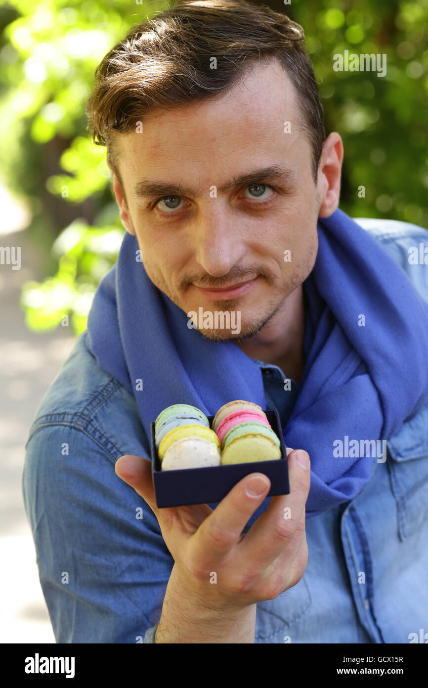 handsome young man with a box of French macaroons Stock Photo - Alamy