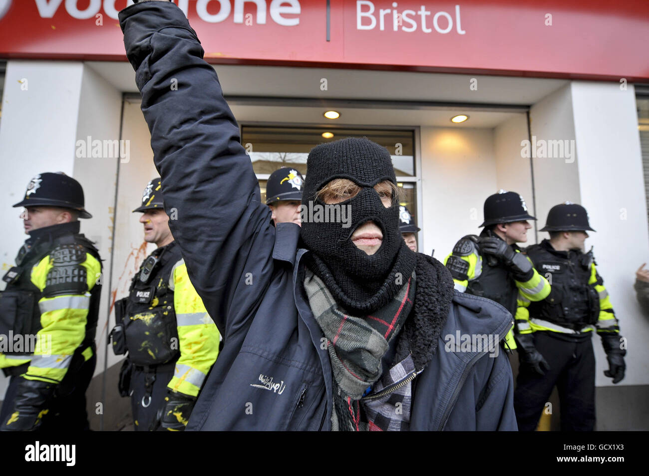 Man in balaclava in front of police officers hi-res stock photography ...