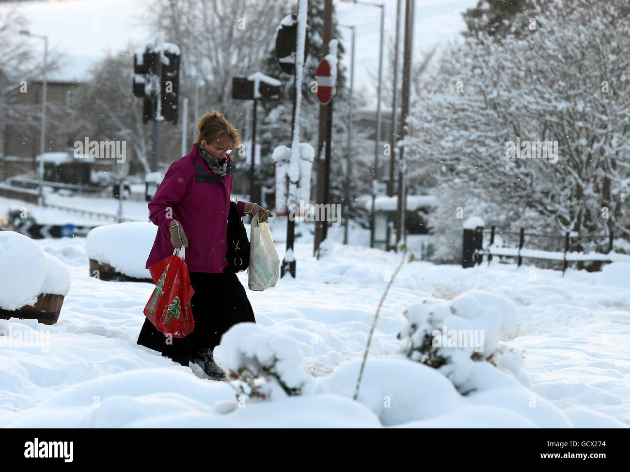 A woman walks along a snow covered path in Dunblane, as heavy snow ...
