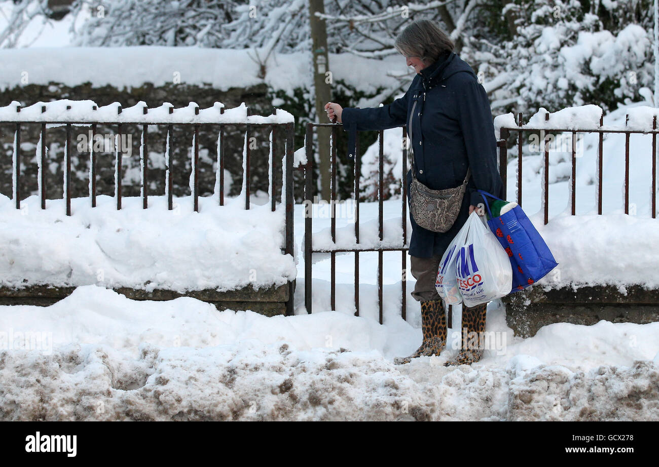 A woman walks along a snow covered path in Dunblane, as heavy snow ...