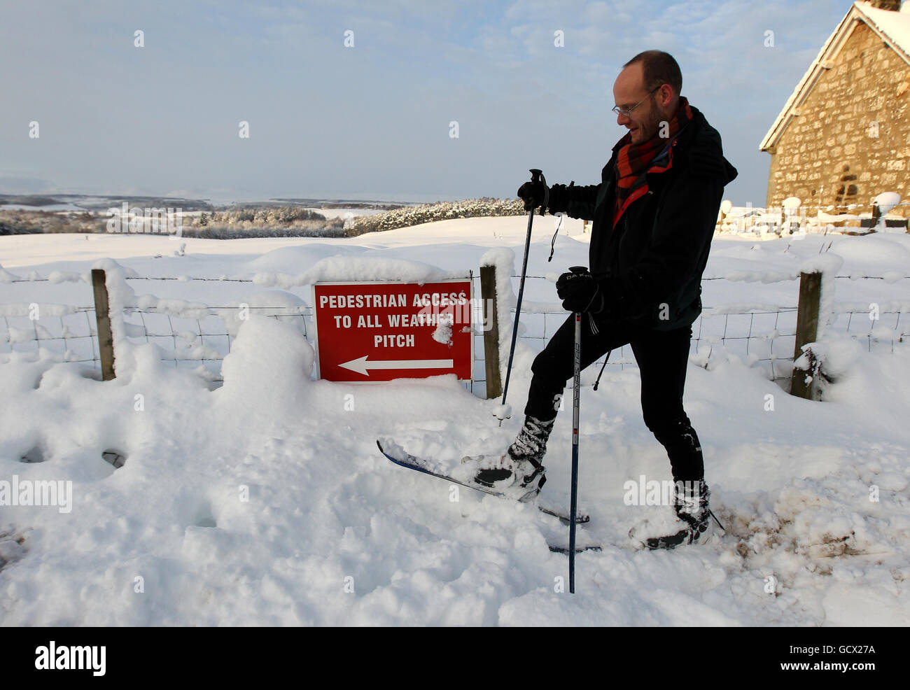 A skier out for a ski passes a sign in Dunblane, as heavy snow ...