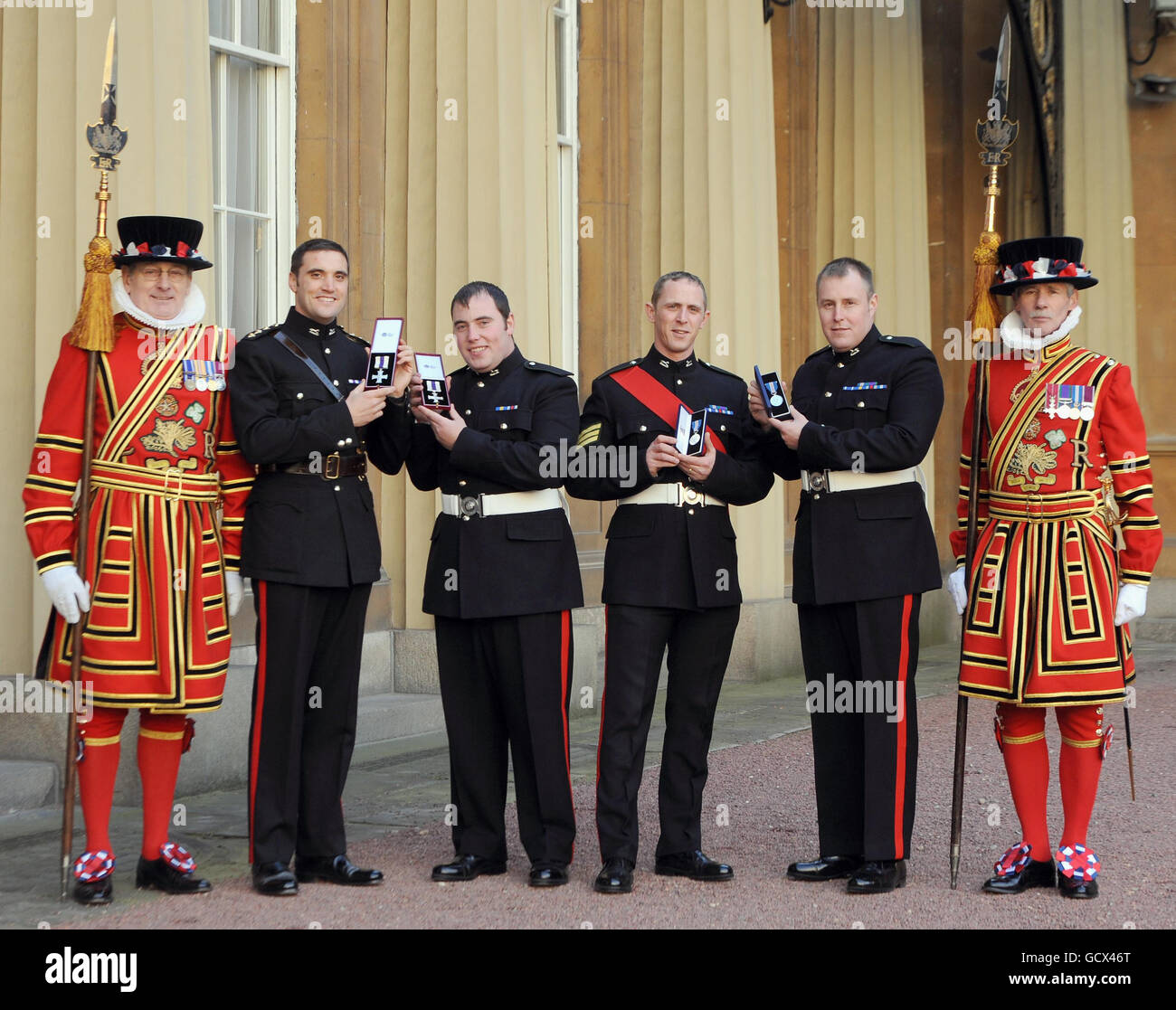 Beefeaters stand either side of (left to right) Captain Colin Lunn with ...