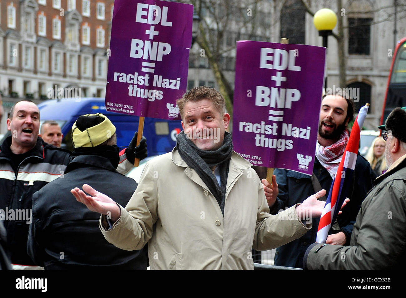 Demonstrators protest as BNP member Richard Barnbrook awaits the ...