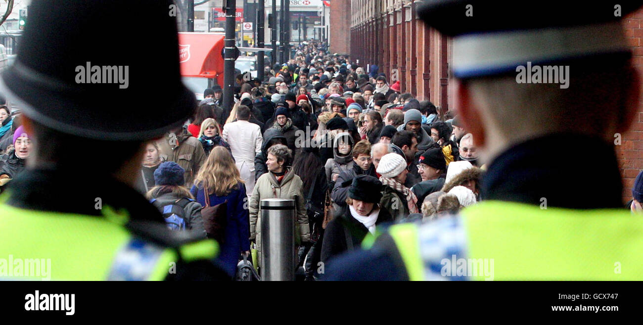 Police watch as hundreds of people queue outside St Pancras Station in ...