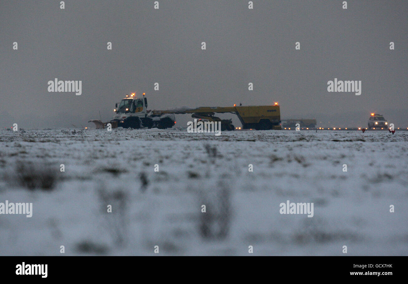 Snow ploughs try and clear the southern runway at Heathrow Airport, as ...