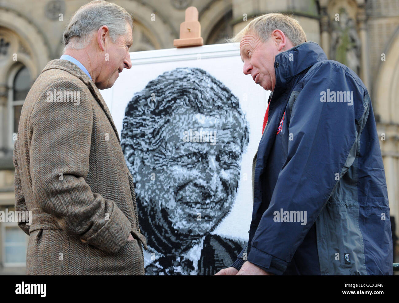 The Prince of Wales studies a portrait of himself created in wool ...
