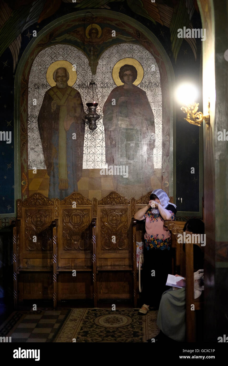 A Romanian woman praying inside Saint Nicholas Russian Church ...