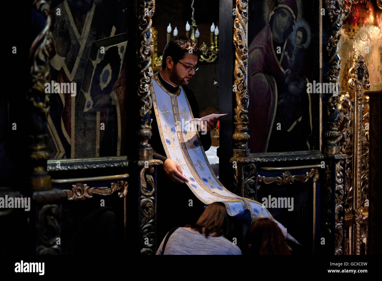 A Romanian Orthodox priest gives blessings to believers inside St ...