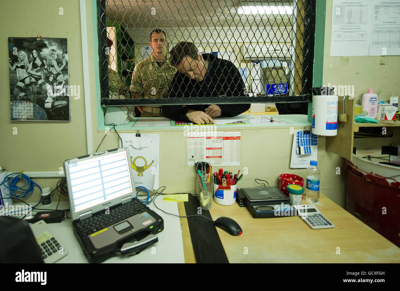 British Prime Minister David Cameron fills in a "Fax Bluey" message to ...