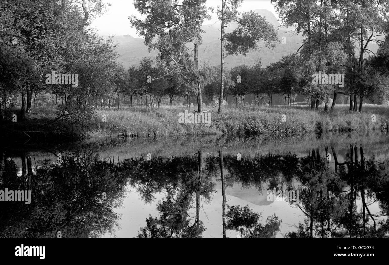 A reflection of trees in still water of the River Lochay in Killin ...