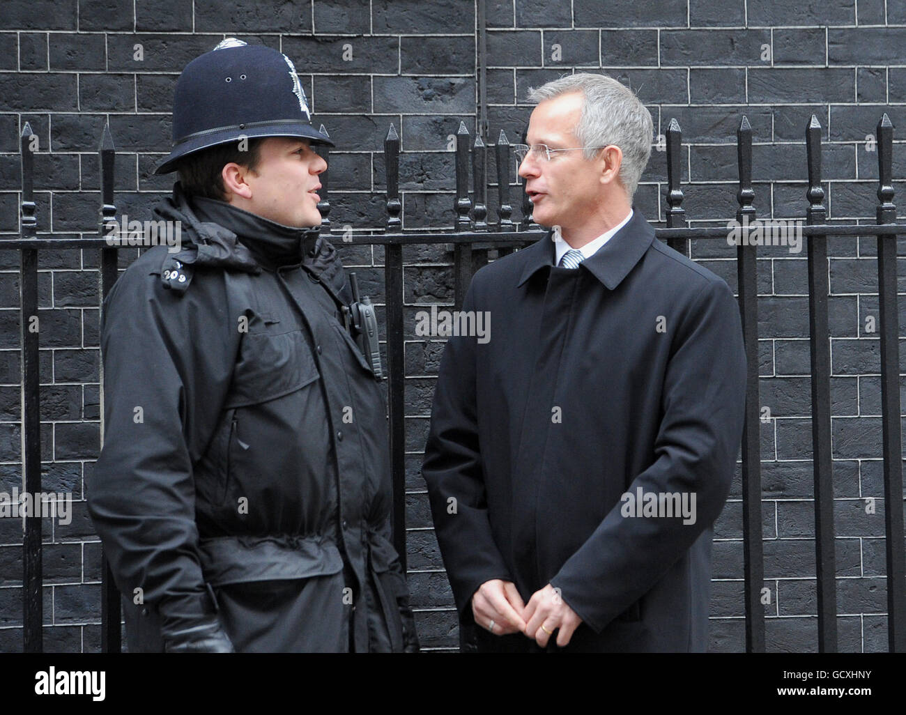 Brian Paddock speaks with a police officer as he leaves after a cabinet ...