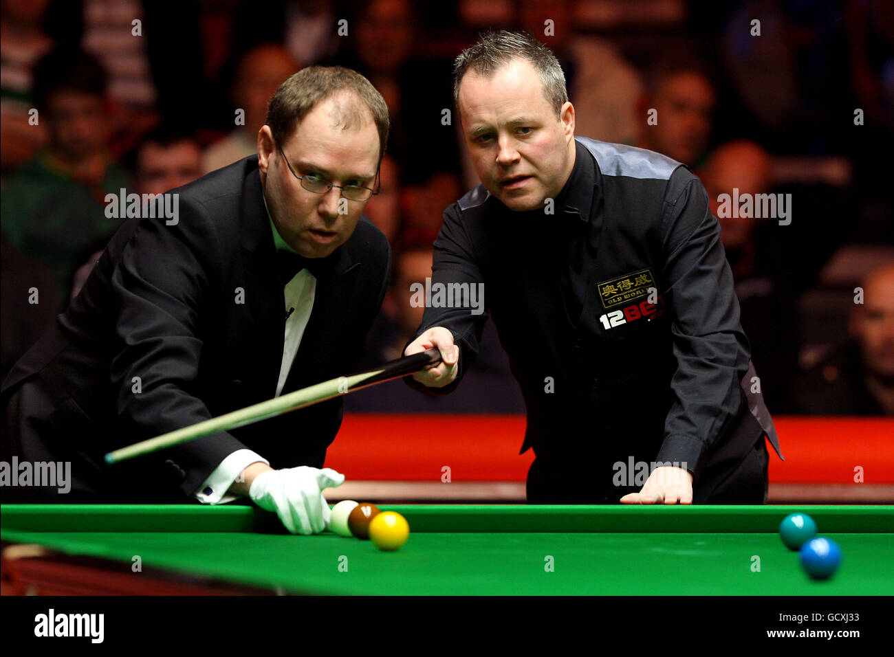 Scotland's John Higgins (right) with the referee (left) during his ...