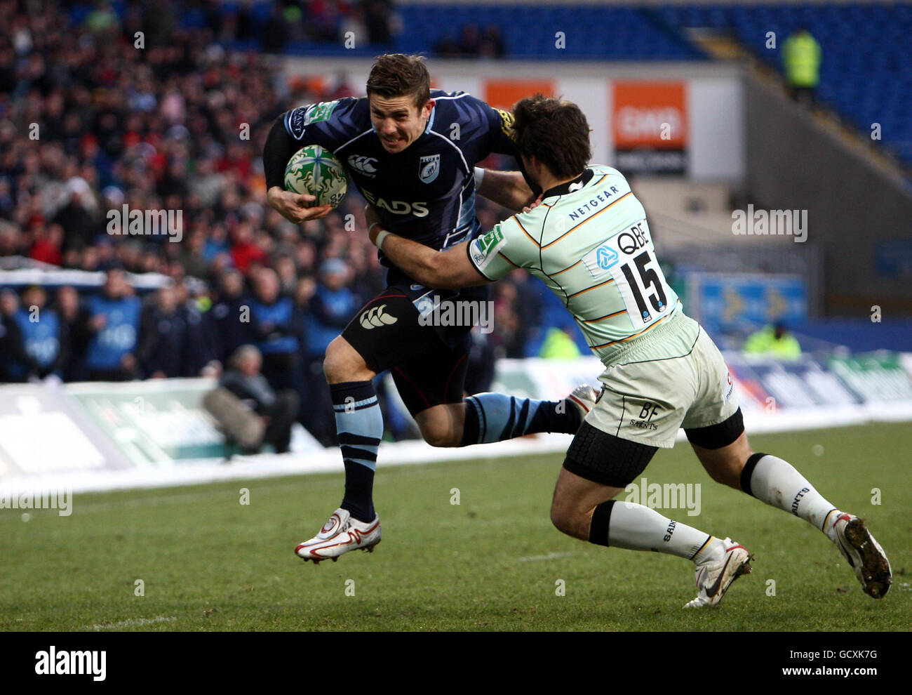 Cardiff Blues' Richard Mustoe is held by Northampton Saints Ben Foden ...