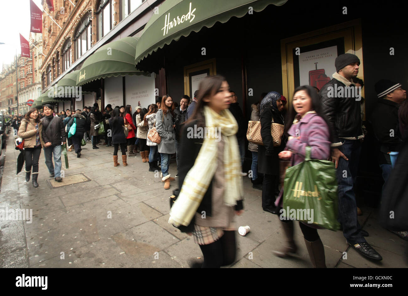 Shoppers queue outside Harrods during the opening of it's winter sale ...