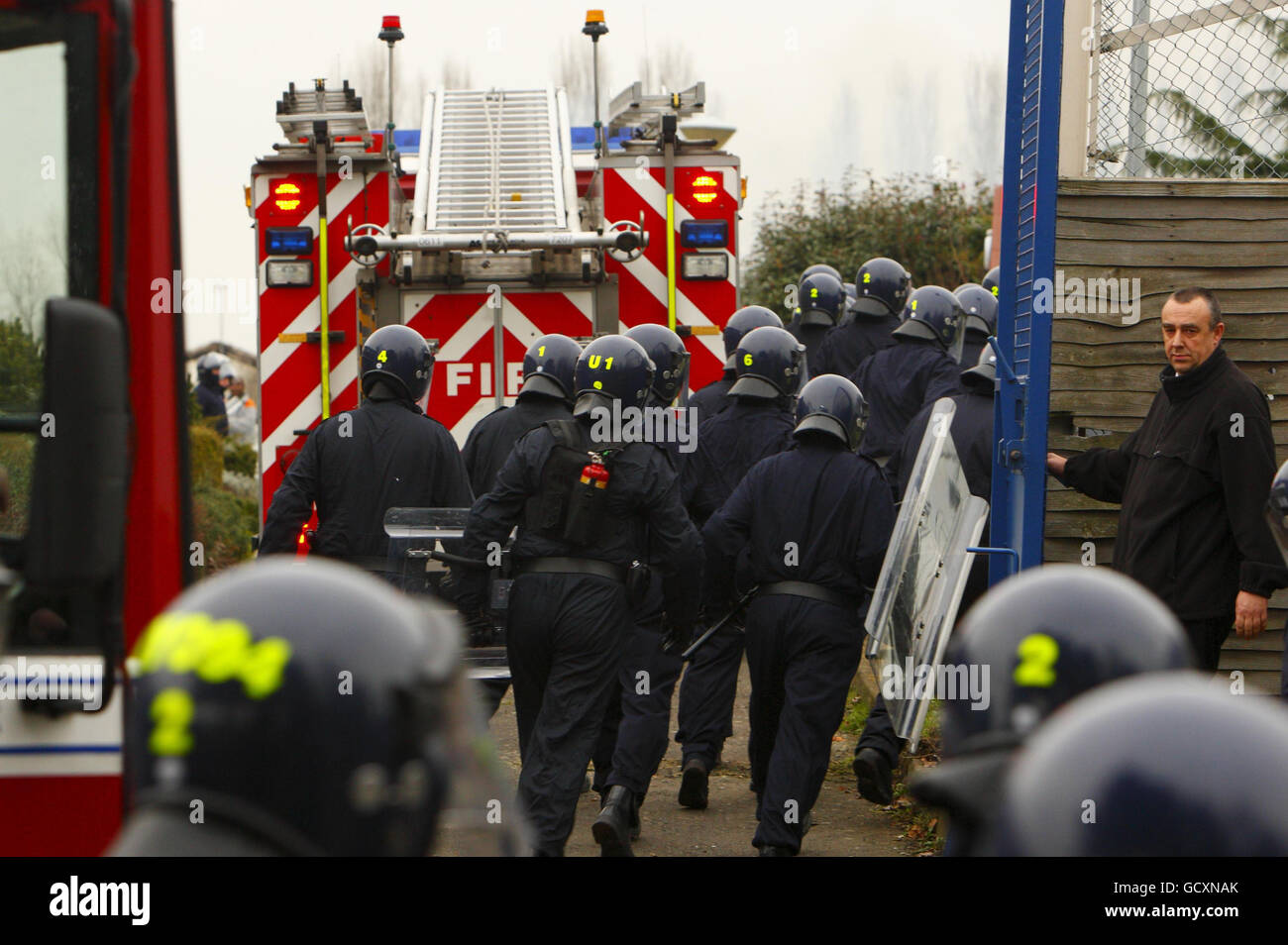 Specialist prison officers escort fire fighters in to HMP Ford near ...
