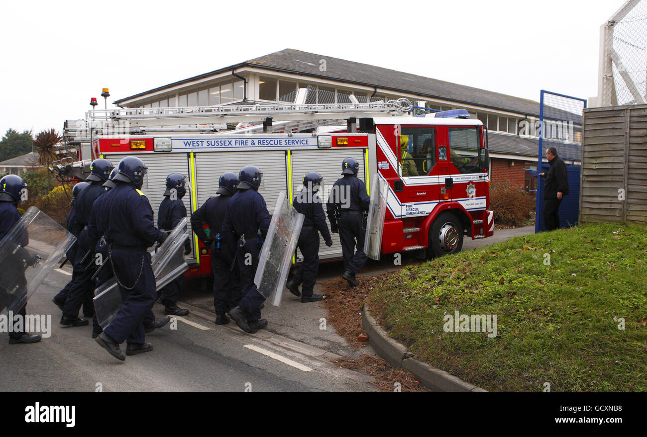 Specialist prison officers escort fire fighters in to HMP Ford near ...