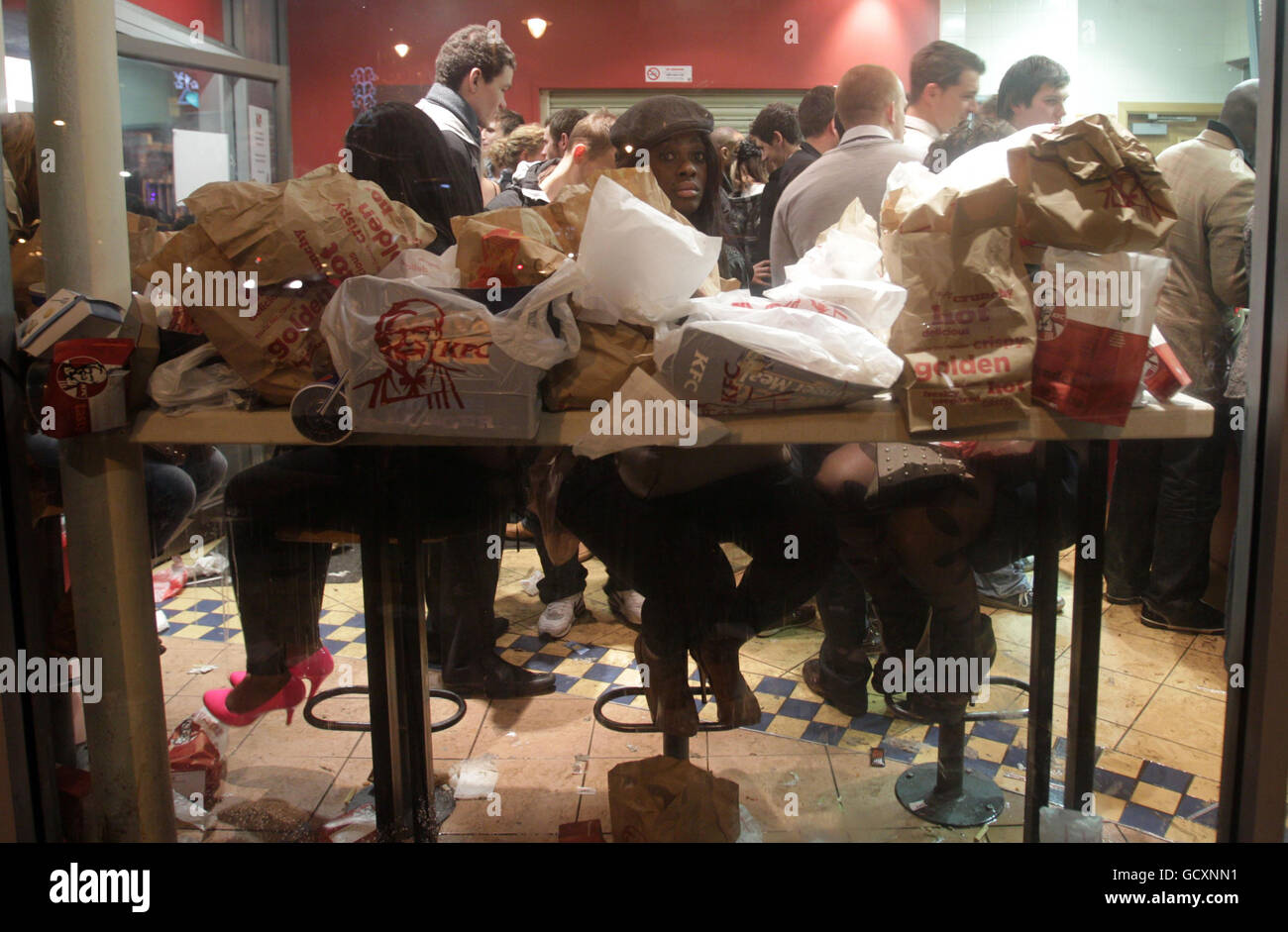 People eating in a fast food chain after the New Year's Eve ...