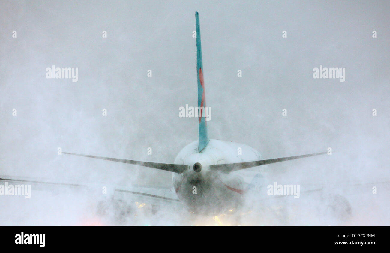 A plane throws up clouds of snow as it prepares for take off at Gatwick ...