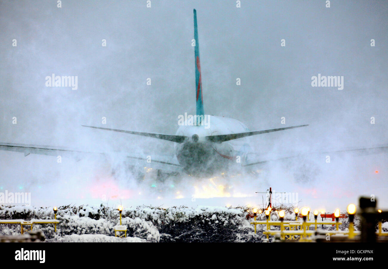 A plane throws up clouds of snow as it prepares for take off at Gatwick ...