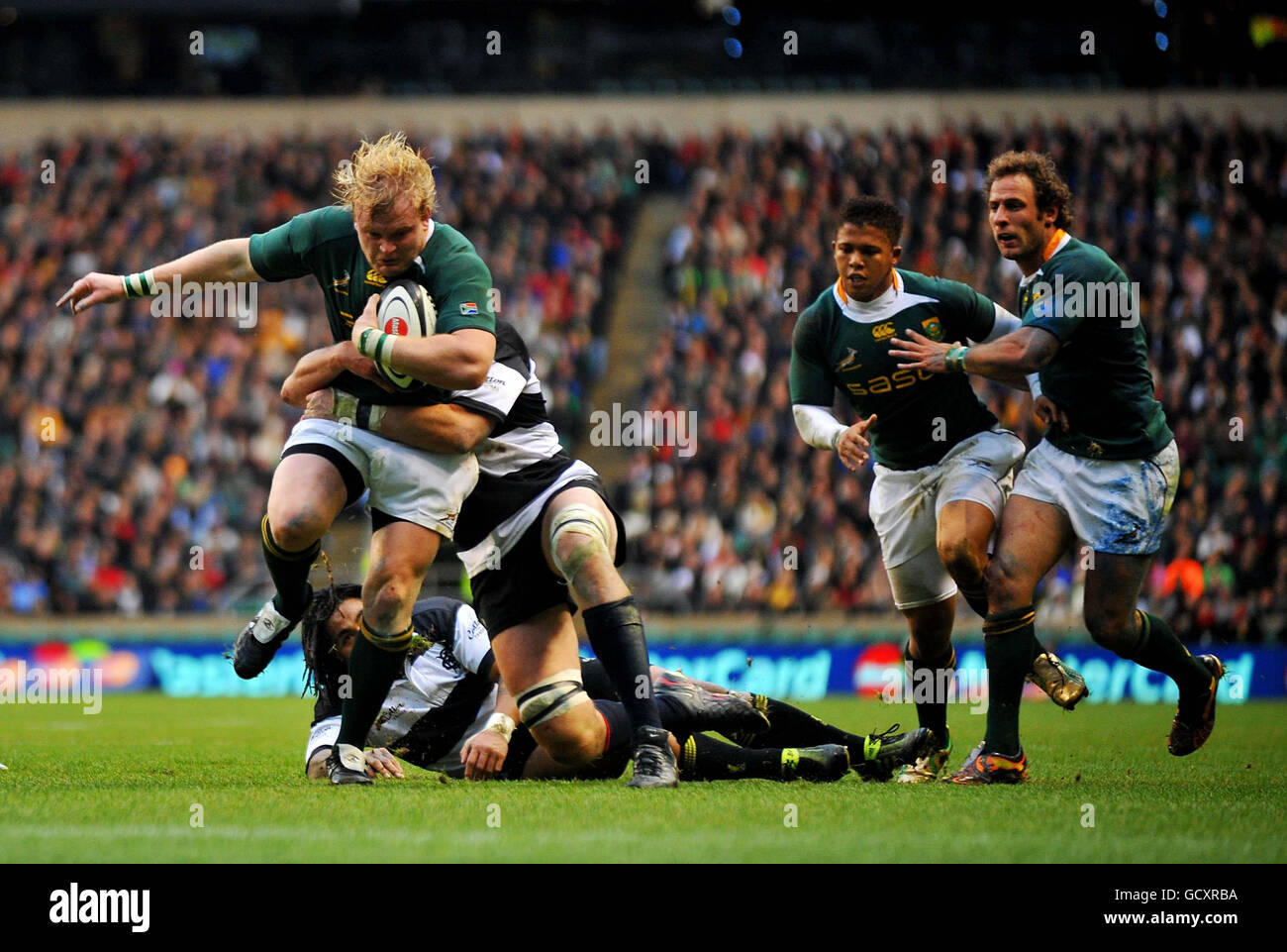 South Africa's Adriaan Strauss is tackled as he runs at the Barbarians ...