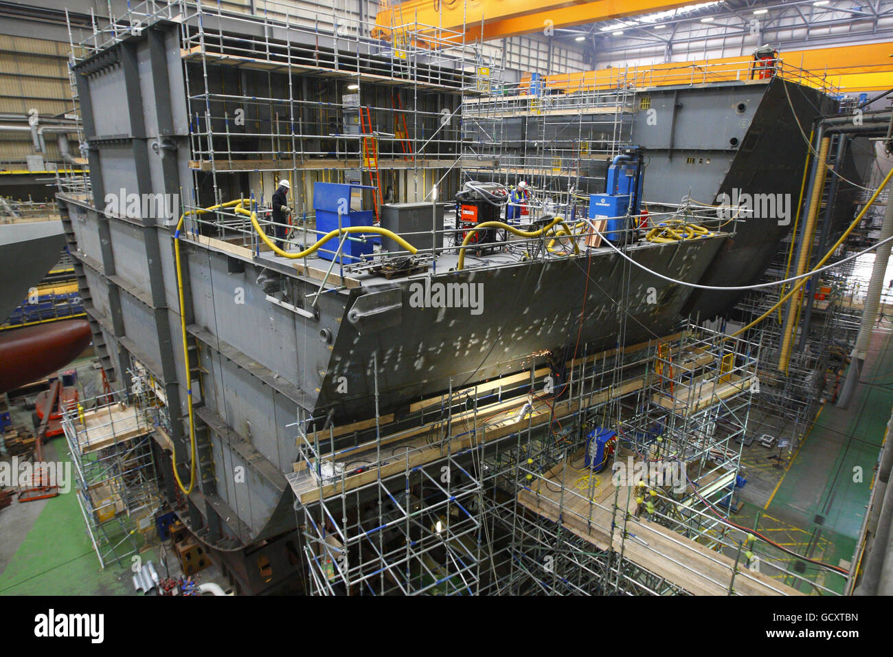 Ship builders construct a section of the first of two Queen Elizabeth ...