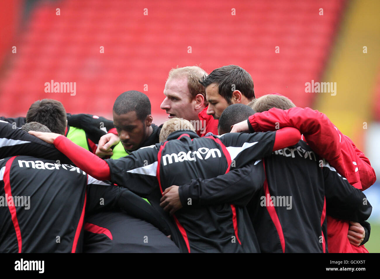 Charlton athletic players in a group huddle during pre match training ...