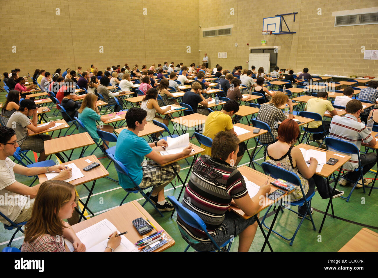 A-level students sit an A-level maths exam inside a sports hall Stock ...