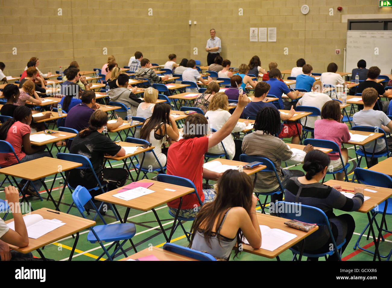 A-level students sit an A-level maths exam inside a sports hall Stock ...