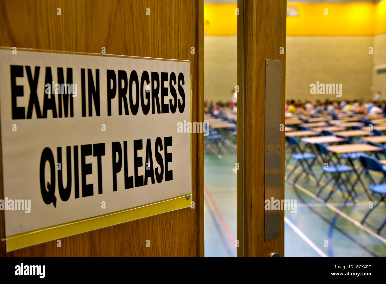 A-level students sit an A-level maths exam inside a sports hall Stock ...