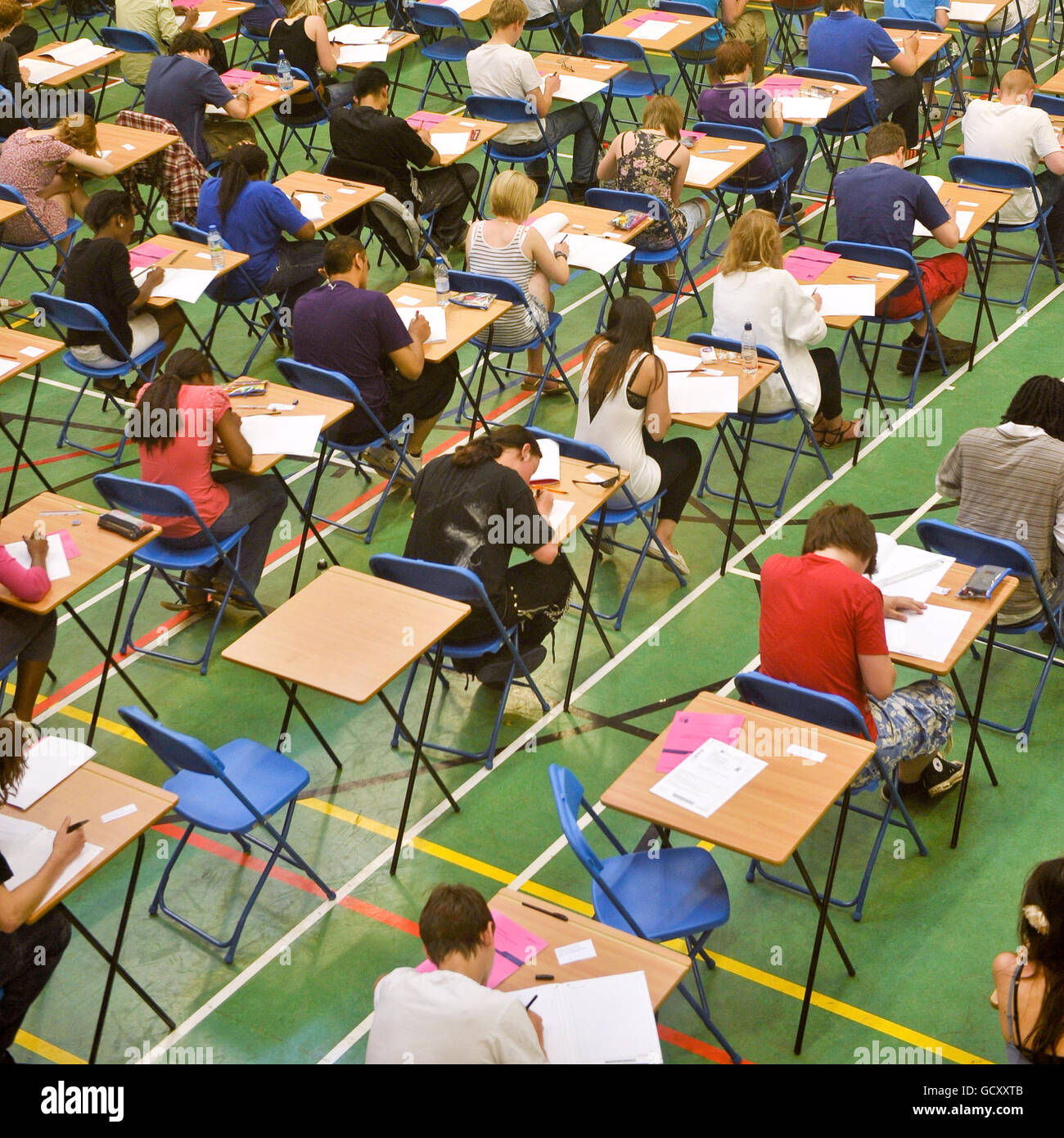 A-level students sit an A-level maths exam inside a sports hall Stock ...