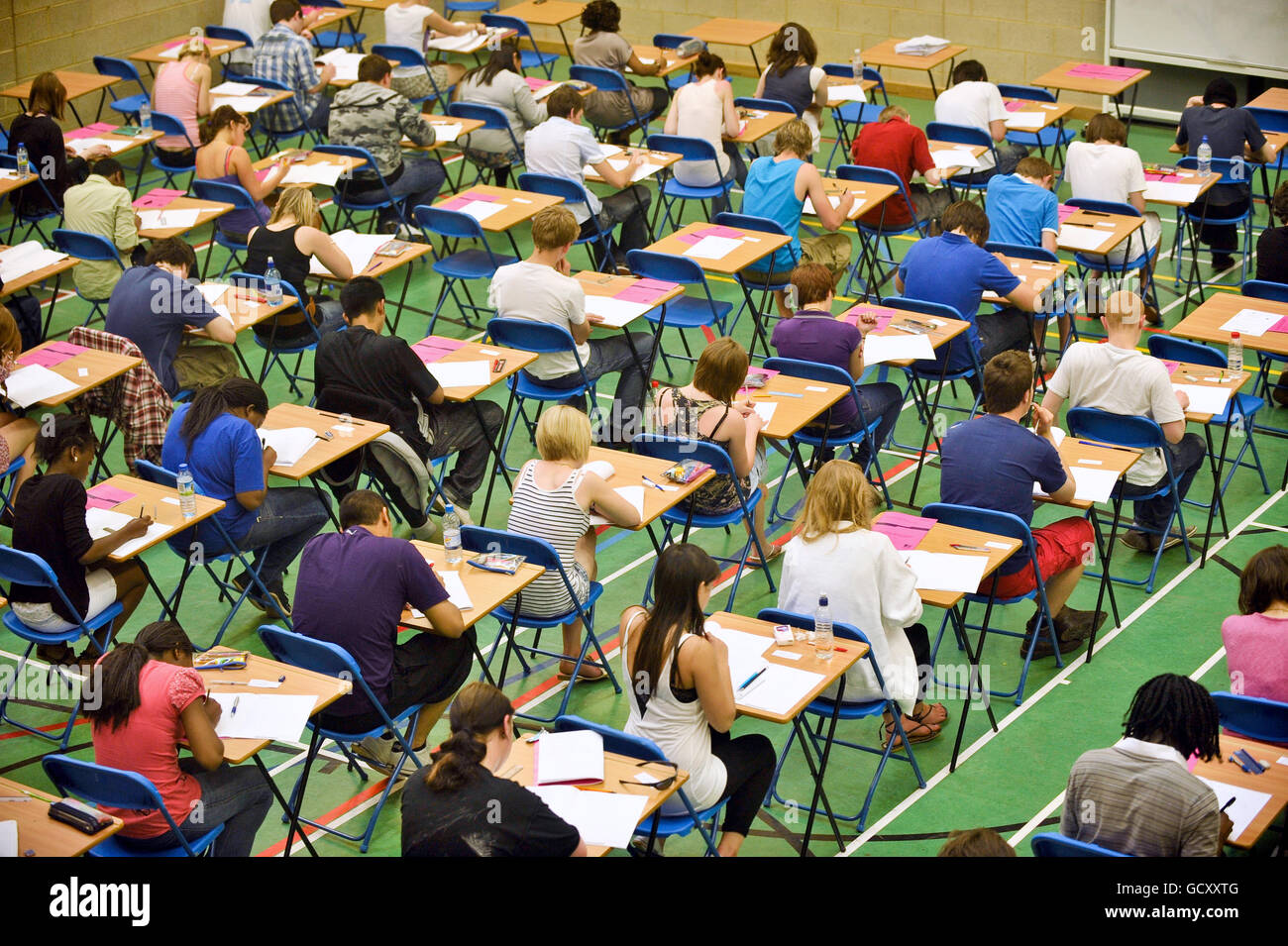 A-level students sit an A-level maths exam inside a sports hall Stock ...