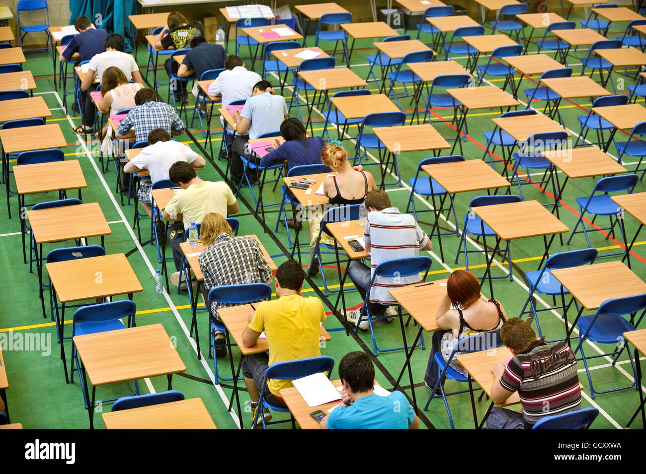 A-level students sit an A-level maths exam inside a sports hall Stock ...