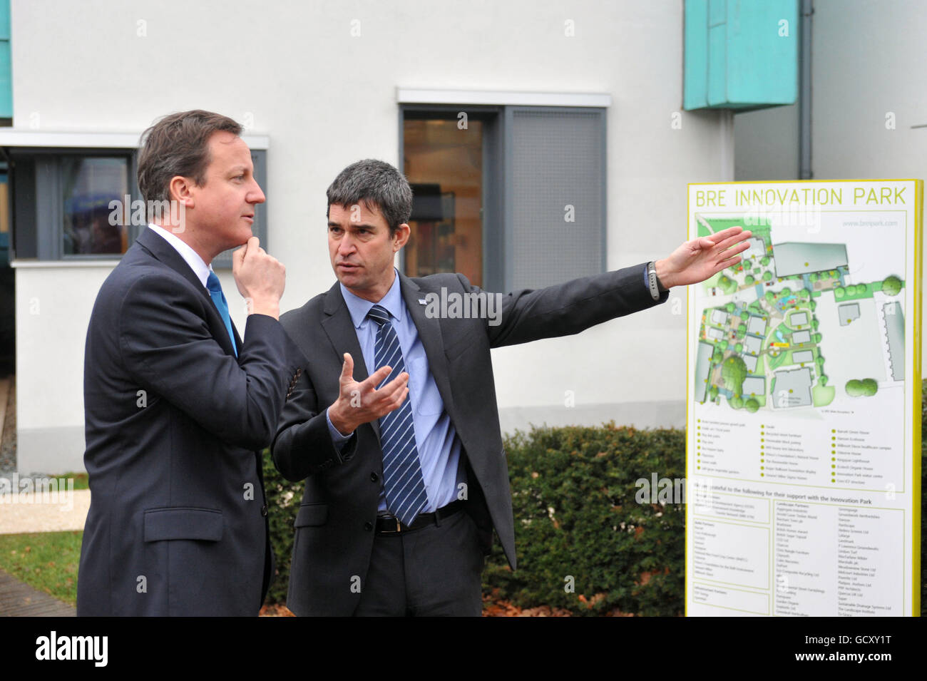 Prime Minister David Cameron speaks with CEO Peter Bonfield (left ...