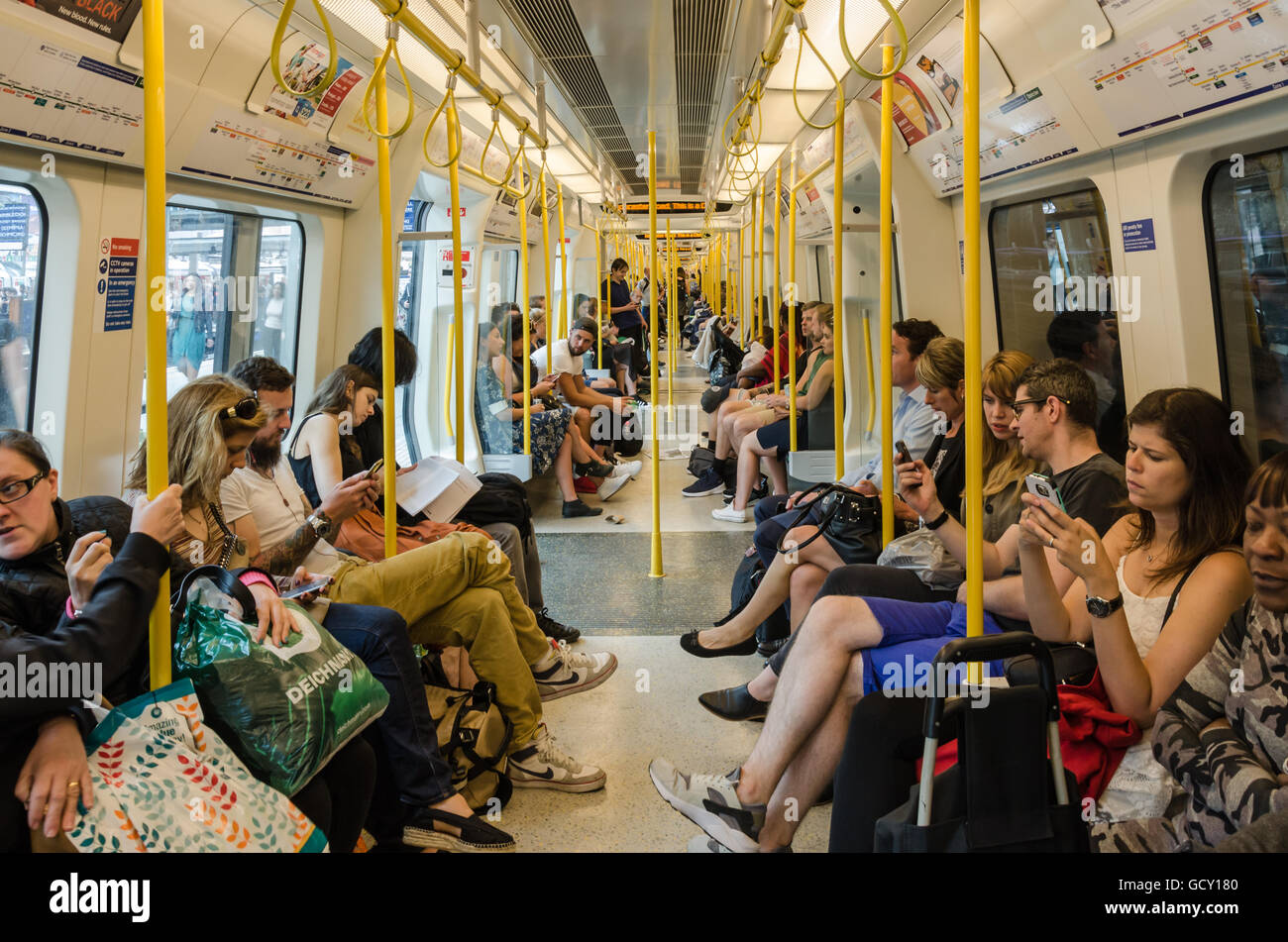 Passengers onboard a District Line train on the London Underground ...
