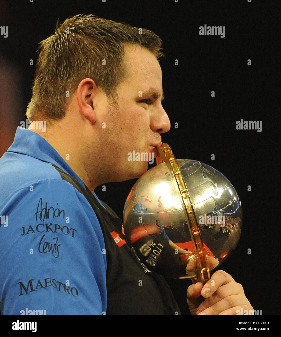 Adrian Lewis kisses the trophy after defeating Gary Anderson during the ...