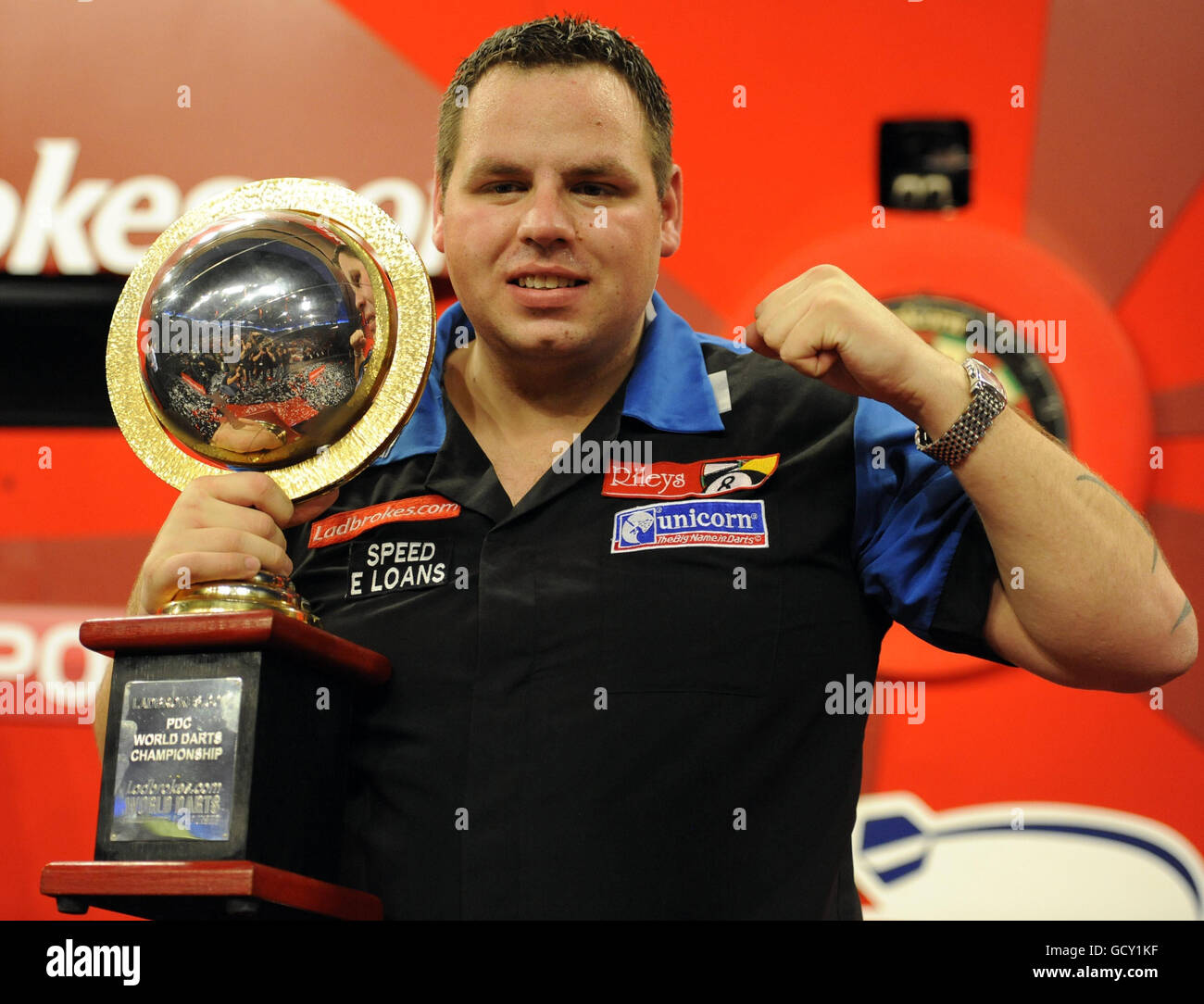 Adrian Lewis celebrates with the trophy after defeating Gary Anderson ...