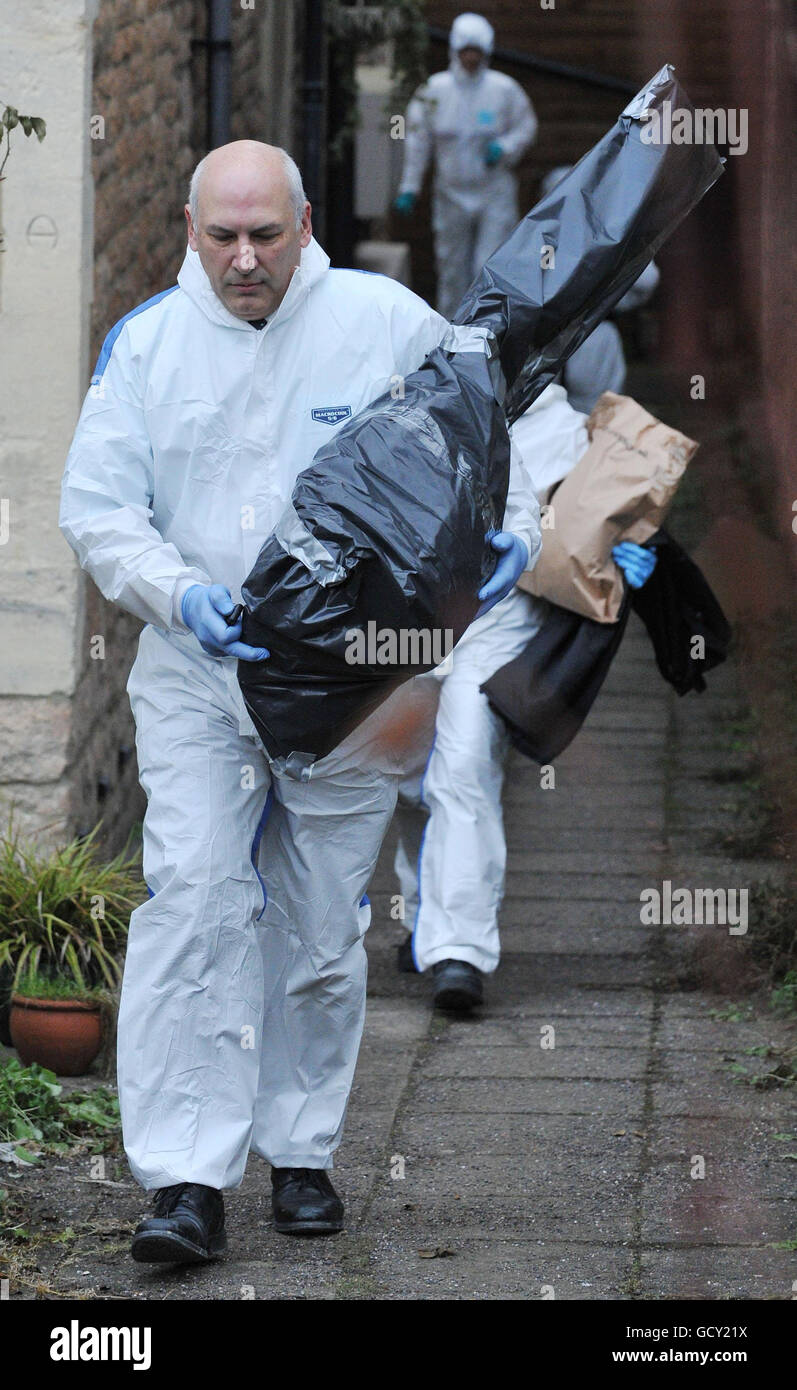 Forensics officers remove evidence from the flat of murder victim hi ...