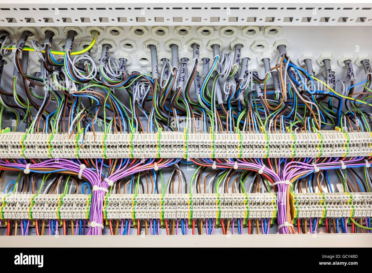 in an fuse box there are an lot of electrical cables with tar Stock ...