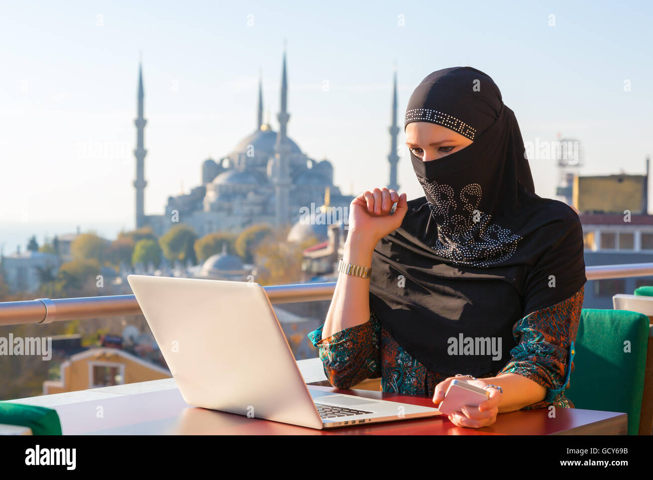 Traditionally dressed Muslim Woman working on computer Stock Photo - Alamy
