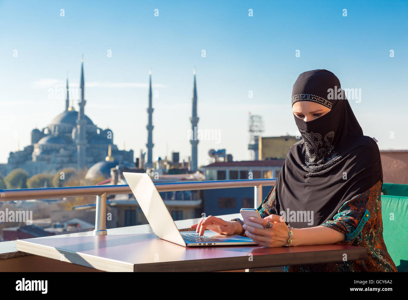 Traditionally dressed Muslim Woman working on computer Stock Photo - Alamy