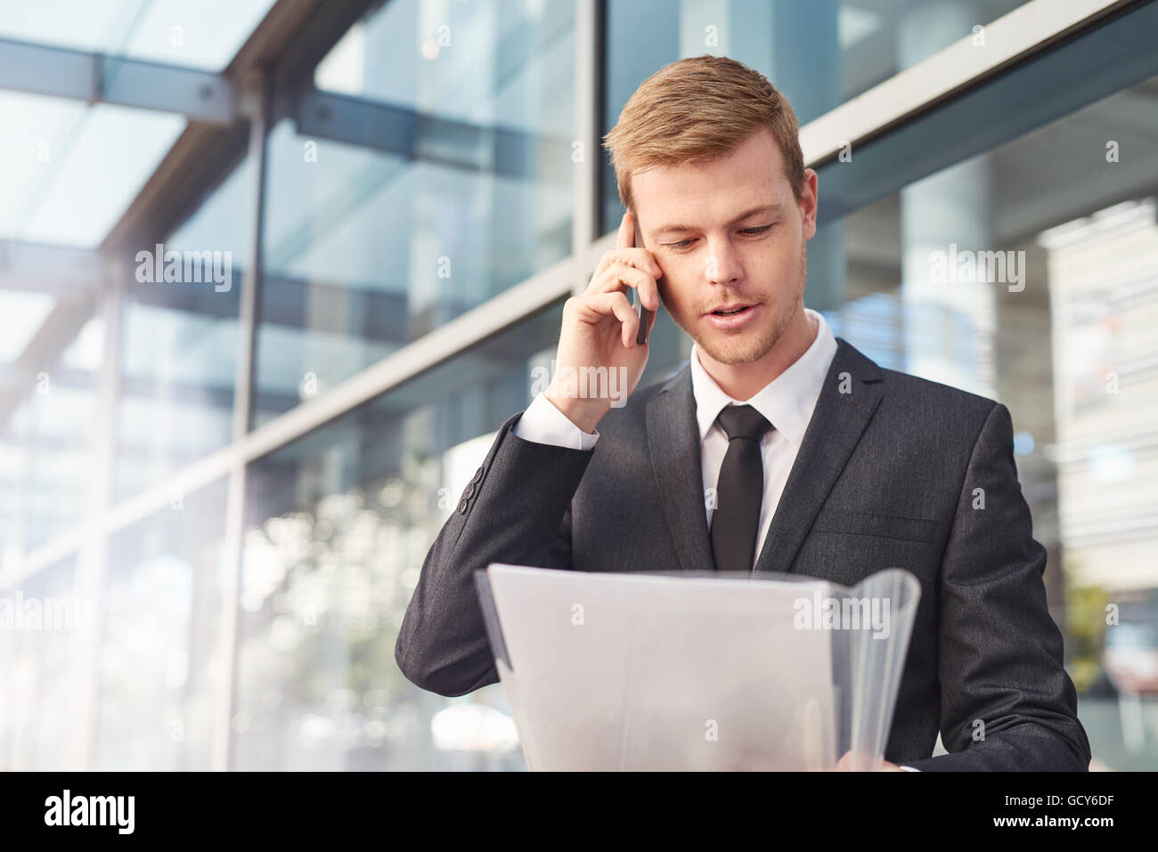 His cellphone keeps him in touch with the office Stock Photo - Alamy