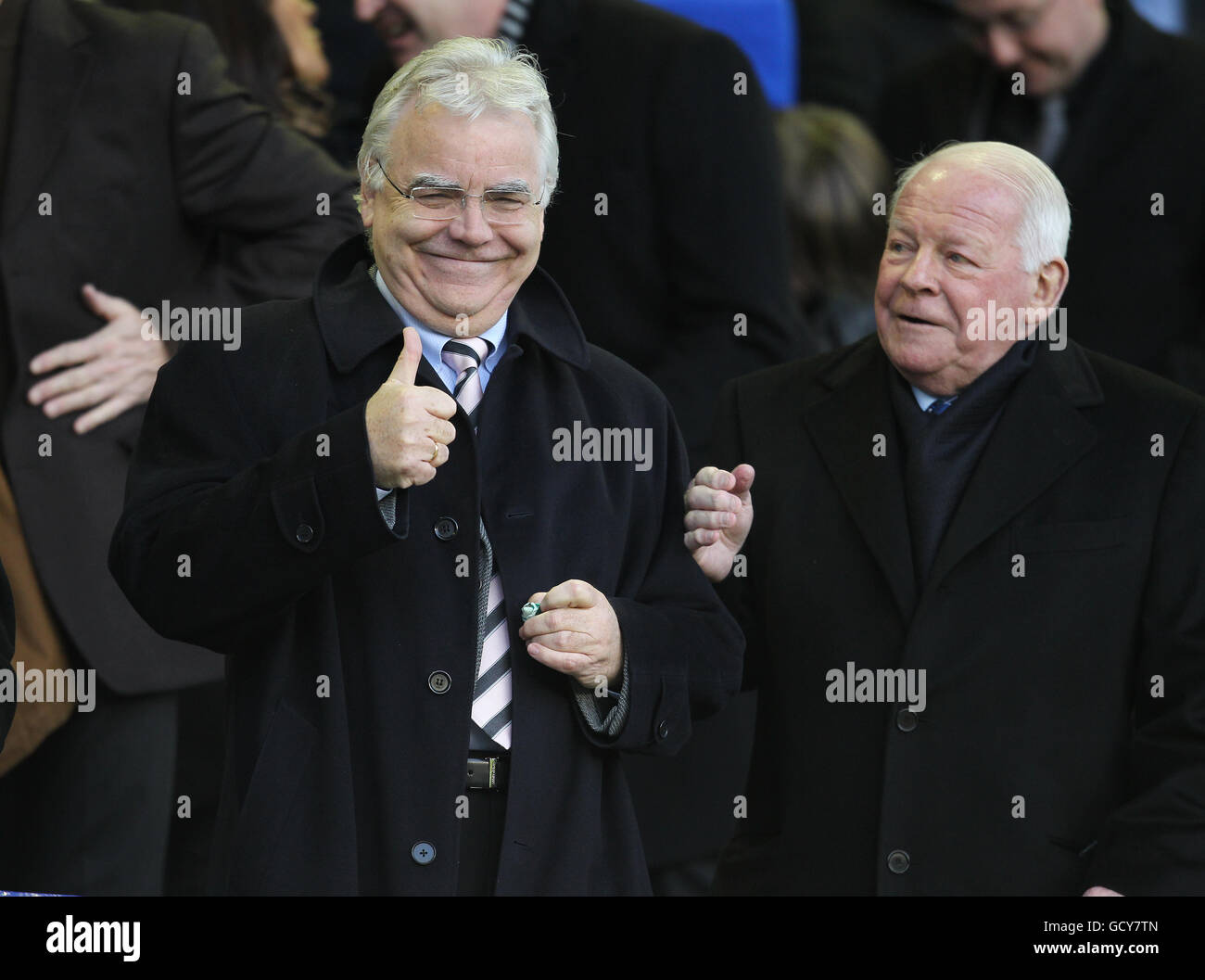 Everton chairman Bill Kenwright (L) gives a thumbs up to the fans along ...