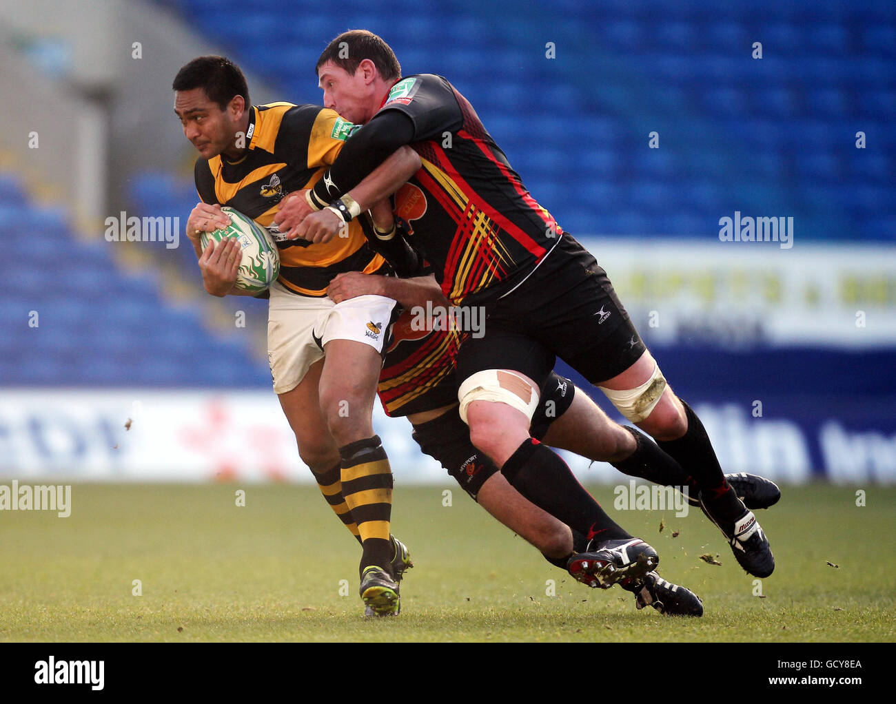 Wasps Steve Kefu is tackled by Dragons' Adam Jones and Tom Riley during ...