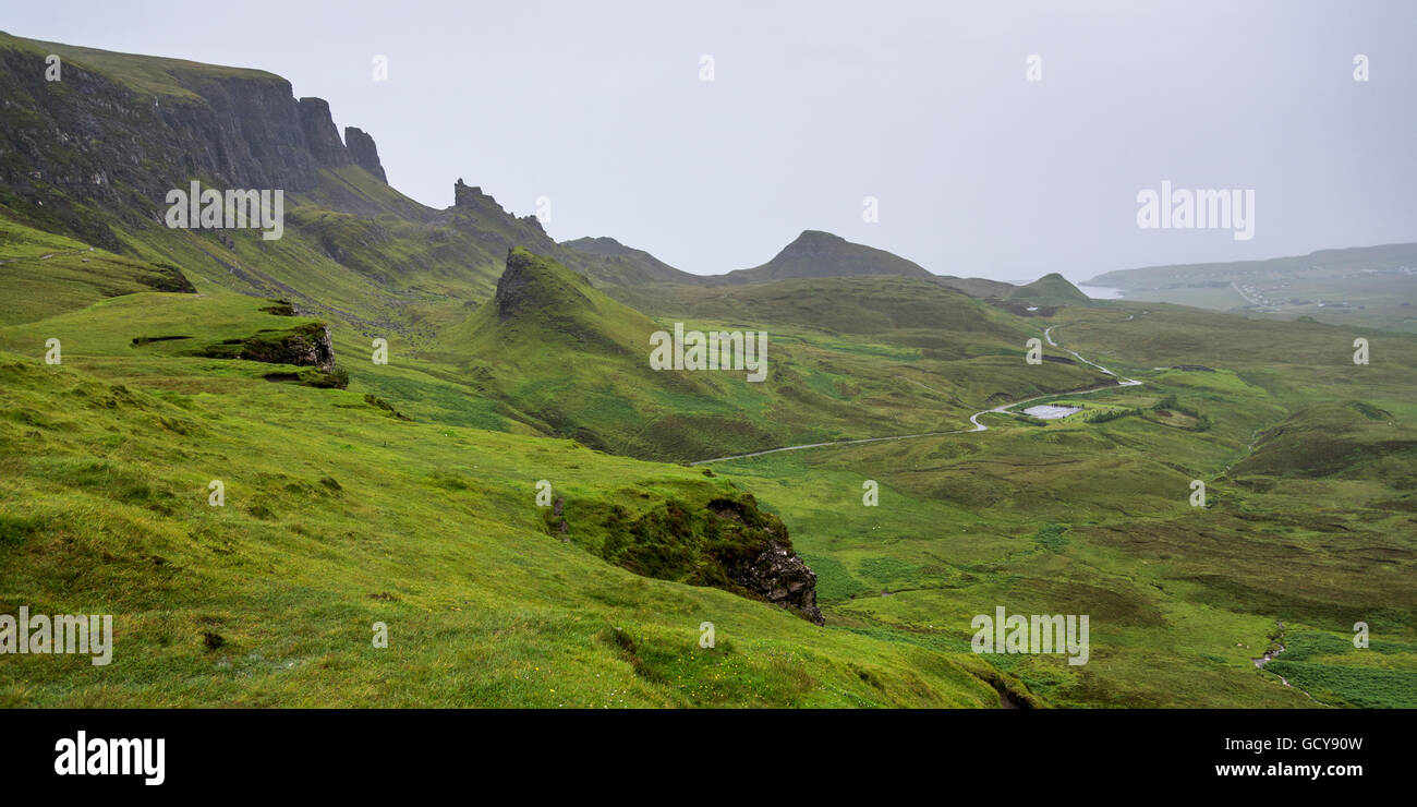 Fog over the lush green landscape with cliffs and peaks; Staffin ...