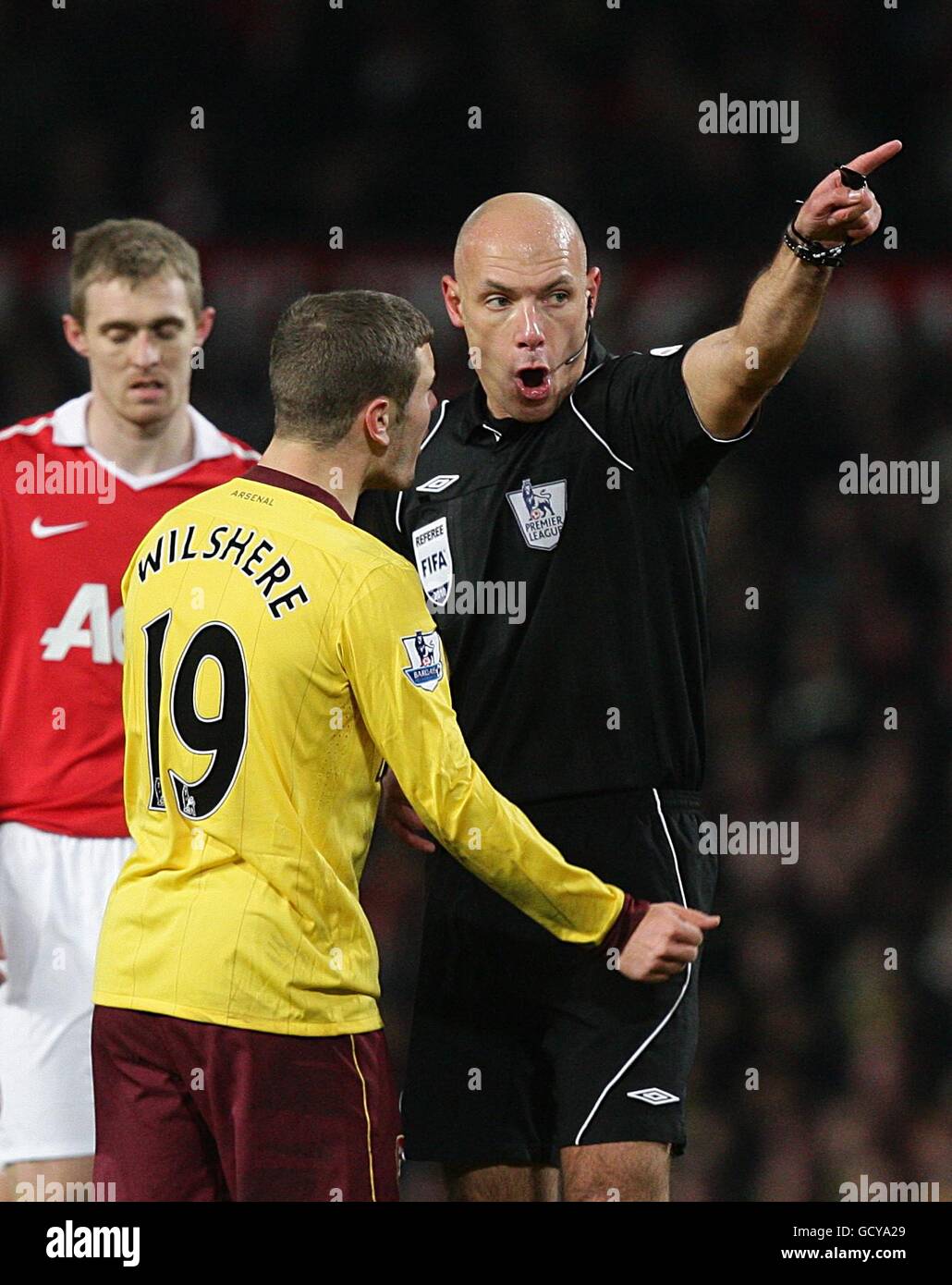 Referee Howard Webb (right) has words with Arsenal's Jack Wilshere ...