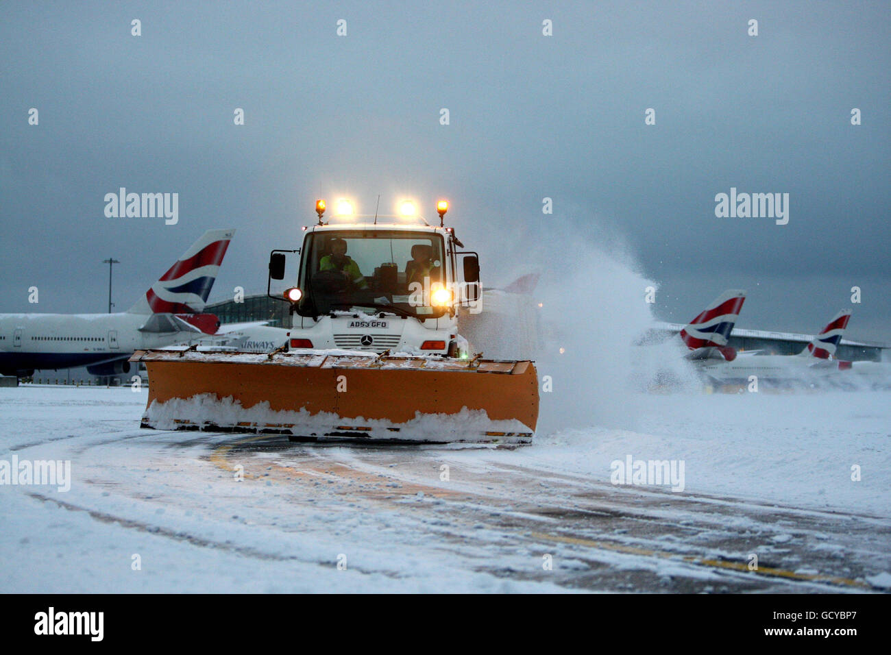 Snow ploughs clear the taxi ways at Heathrow Airport after heavy ...